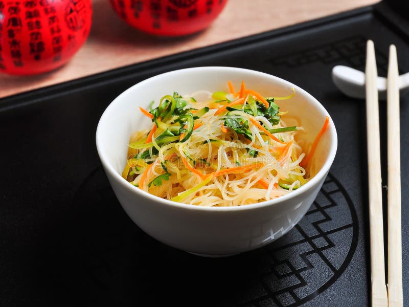 Cellophane with Vegetables in a White Bowl and a Black Background Stock ...
