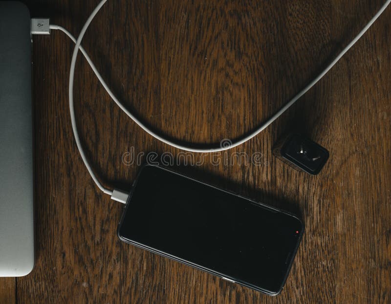 Cellphone Connected To Computer Stock Photo - Image of computer, brown ...