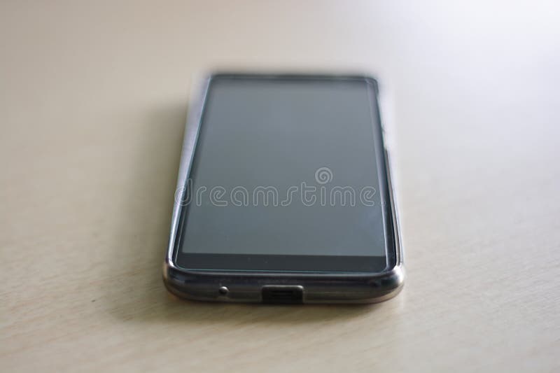 Cellphone on the desk stock photo. Image of display - 148439620
