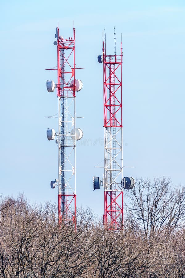 Cellular Mobile Communication Towers in Spring Forest on Blue Sky ...