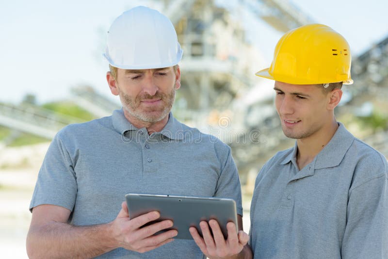 Cement Factory Workers Looking at Tablet Stock Image - Image of helmet ...