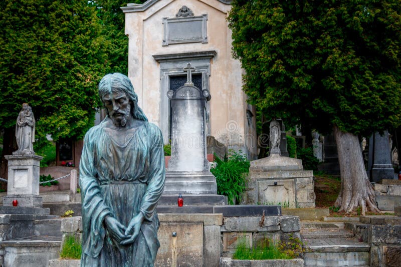 Cemetery with a Sad Man Statue on the Foreground. Stock Image - Image ...