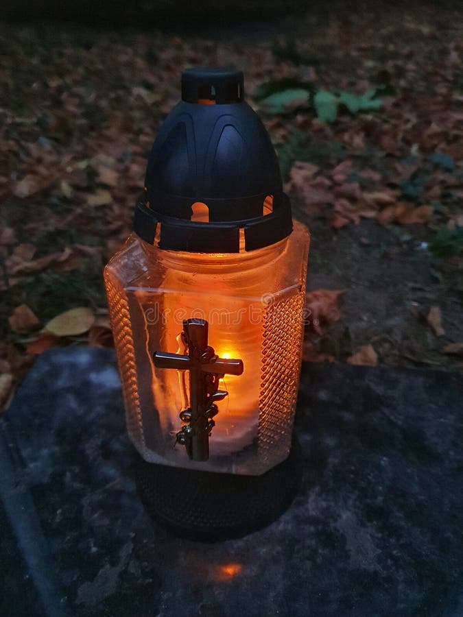 The Cemetery Votive Candle Burns with a Bright Light in the Night Stock ...