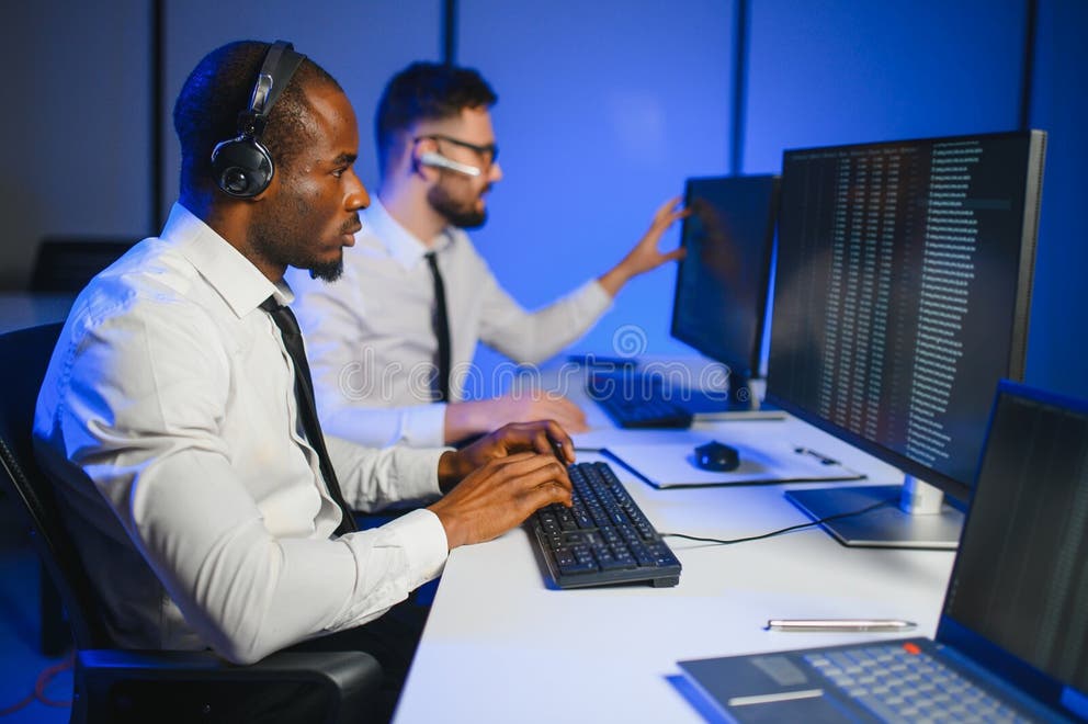 Center of Dispatching Maintenance. Portrait of Men Working Via Headset Microphone while Sitting ...