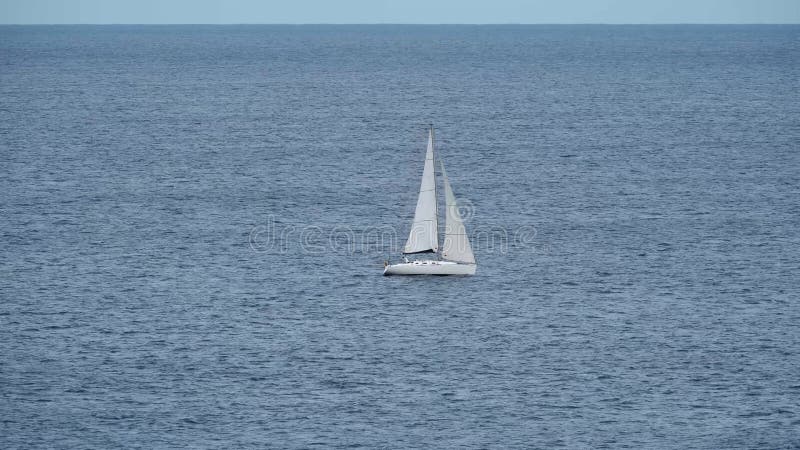 In the Center of the Frame, from Left To Right, a White Sailing Yacht ...