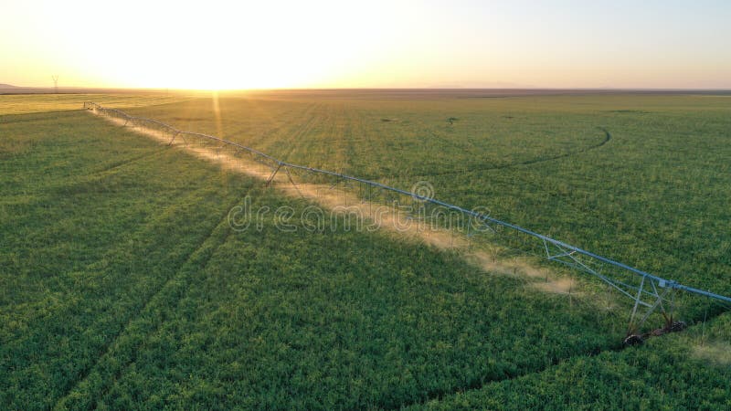 Center Pivot Irrigation System in Field at Sunset. Aerial View Stock ...