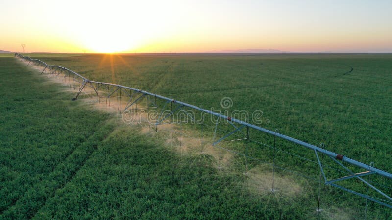 Center Pivot Irrigation System in Field at Sunset. Aerial View Stock ...