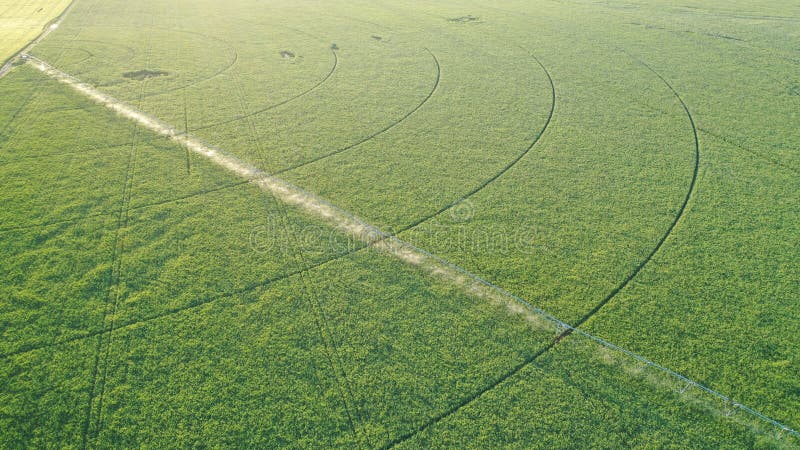 Center Pivot Irrigation System in Field at Sunset. Aerial View Stock ...