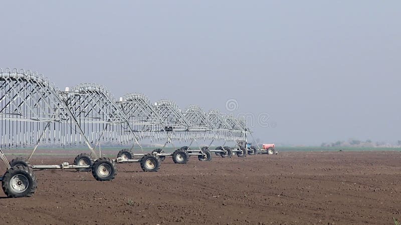 A Sprinkler System Watering Plants in a Garden or Landscape Stock ...