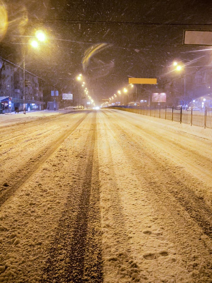 Center of the Snowy Road in the Night City with Snowfall. Stock Image ...