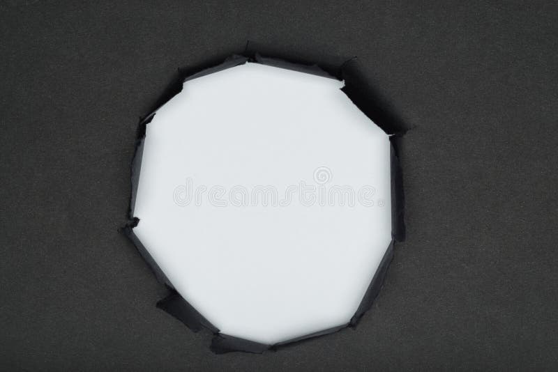 Center Torn Hole in Black Paper Revealing White Background, Space for ...