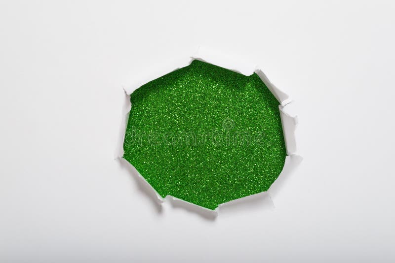 Center Torn Hole in White Paper Revealing a Green Glitter Texture ...
