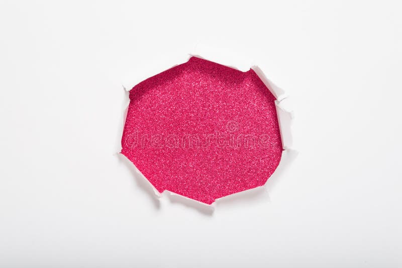 Center Torn Hole in White Paper Revealing a Pink Glitter Texture ...