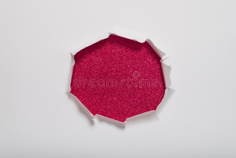 Center Torn Hole in White Paper Revealing a Red Glitter Texture ...