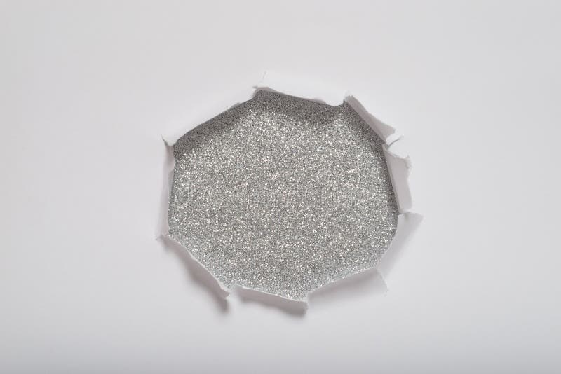 Center Torn Hole in White Paper Revealing a Silver Glitter Texture ...