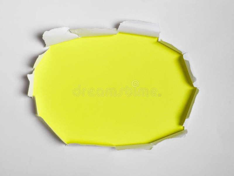 Center Torn Hole in White Paper Revealing a Yellow Background. Space ...