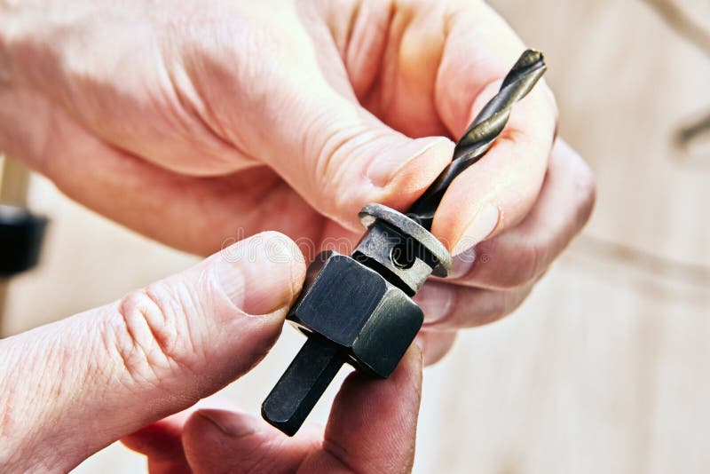 Central Pilot Bit and Drill Attachment Held in Hands, Showing Key ...