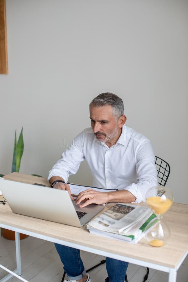 CEO Sitting at His Working Place and Working on the Laptop Stock Photo ...