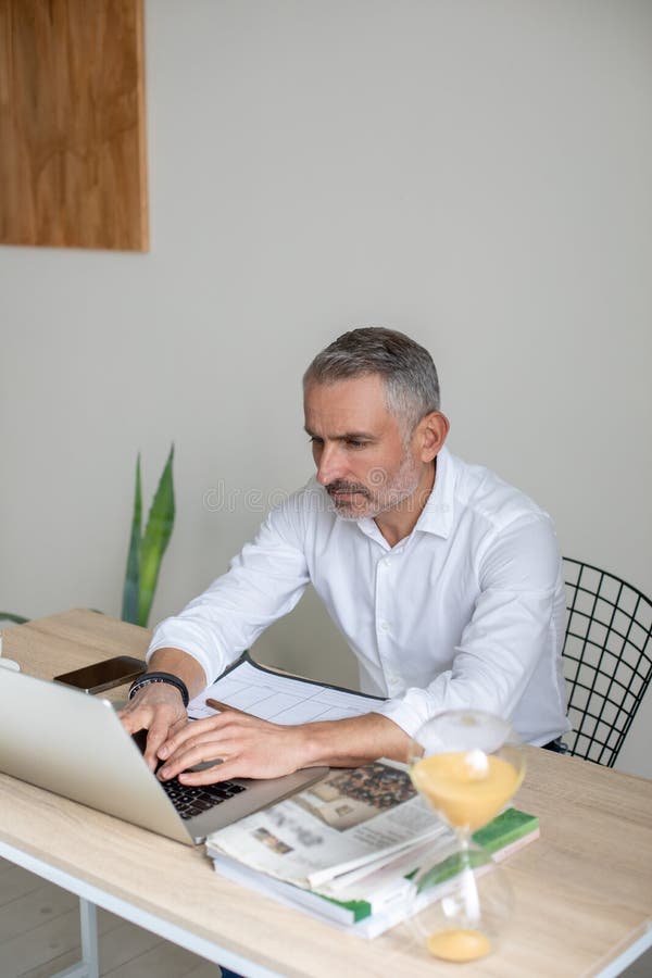 CEO Sitting at His Working Place and Working on the Laptop Stock Photo ...