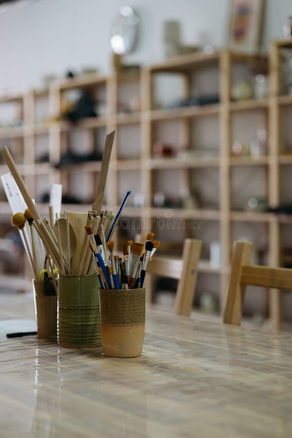 Artistic Pottery Studio Interior with Ceramic Tools and Brushes on a ...