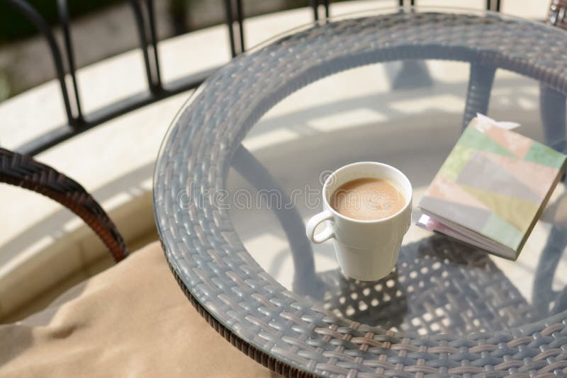 Ceramic Cup of Drink and Notebook with Pen on Glass Table Outdoors ...