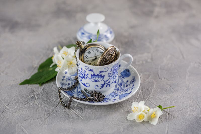 A Ceramic Cup of Green Tea with Jasmine and a Beautiful Clock on a ...