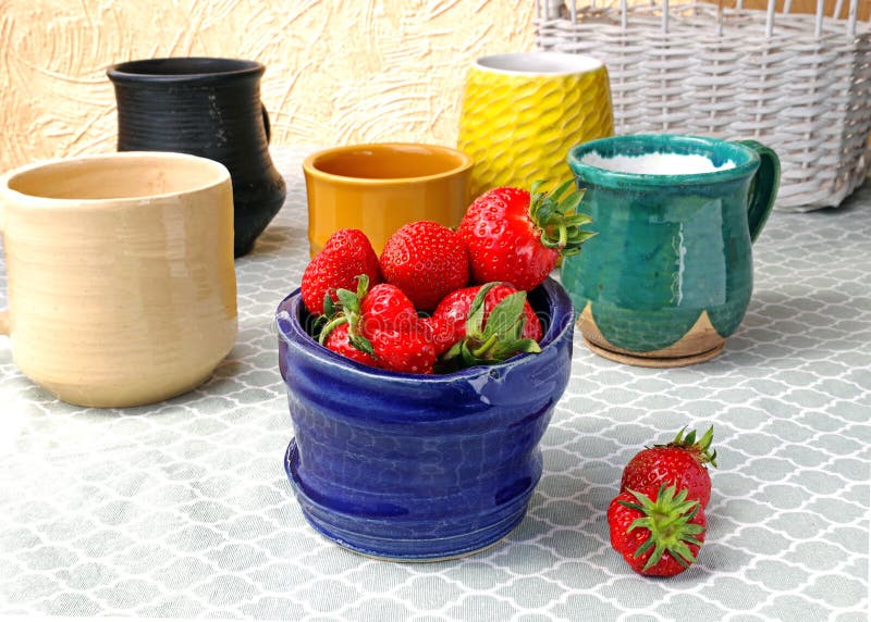Ceramic Cups of Different Colors and Sizes with Strawberry Stock Photo ...