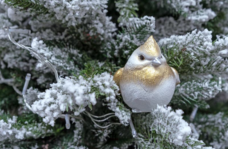 Ceramic Figurine of a Bird with a Golden Crest on the Snow-covered ...