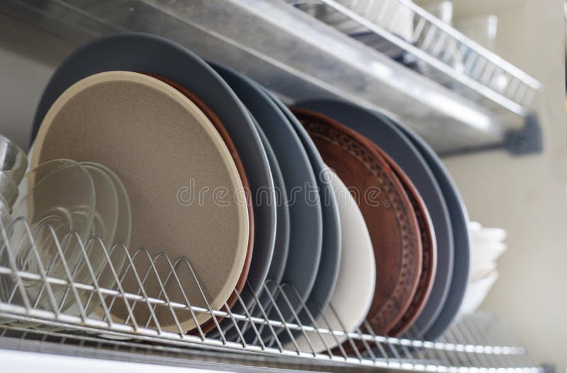 Ceramic and Glass Plates of Different Sizes on a Stand in the Kitchen ...