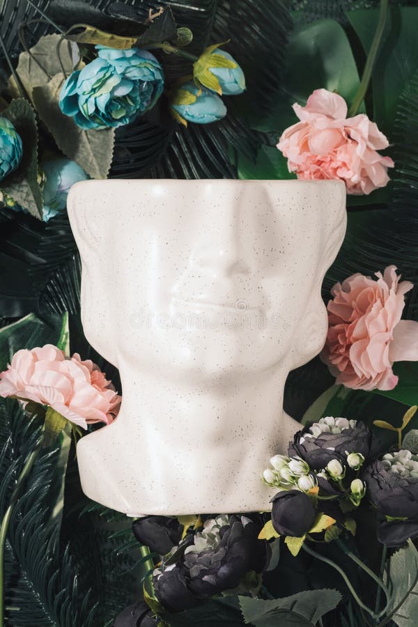 Ceramic Head Sculpture on a Various Flowers and Leaves. Stock Image ...