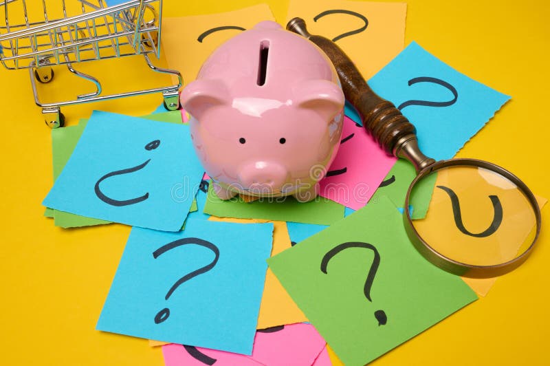 Ceramic Piggy Bank and Stickers with Drawn Question Marks on a Yellow ...