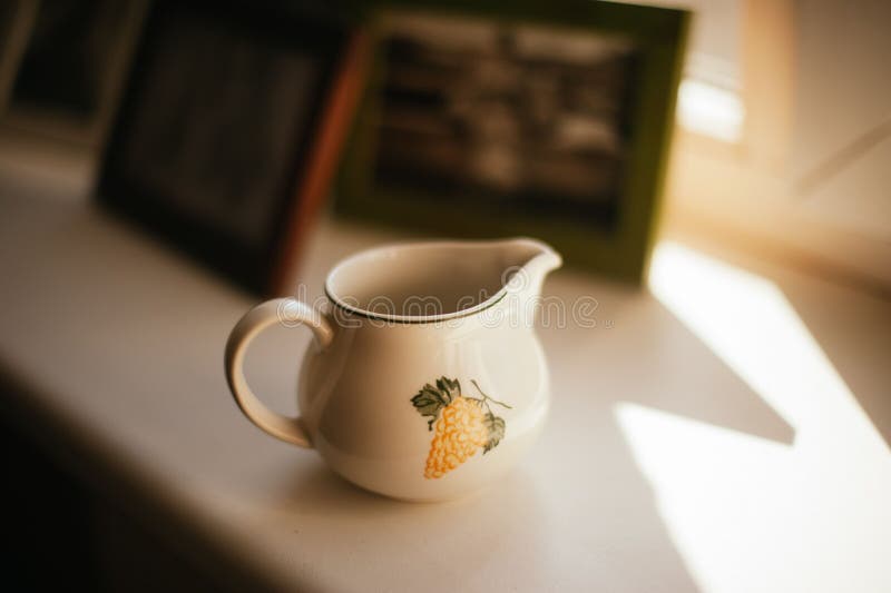 Ceramic Pitcher on a Shelf in Front of a Rectangular Picture Frame ...