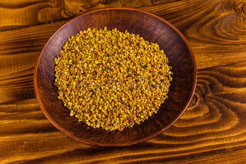Ceramic Plate with Bee Pollen on Wooden Table Stock Photo - Image of ...