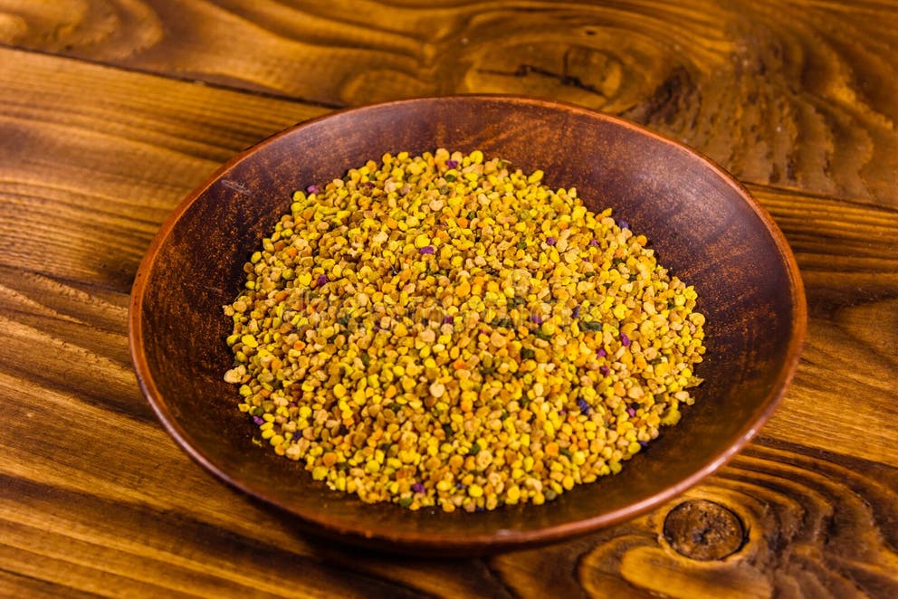 Ceramic Plate with Bee Pollen on Wooden Table Stock Image - Image of ...