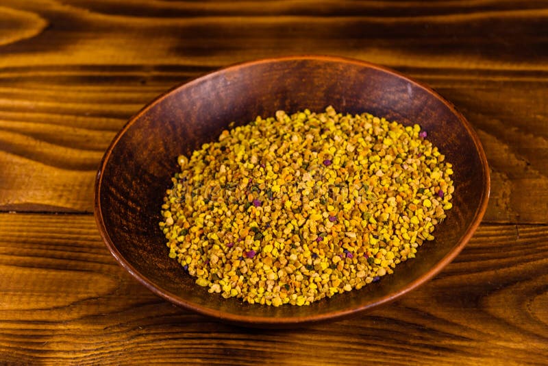 Ceramic Plate with Bee Pollen on Wooden Table Stock Photo - Image of ...