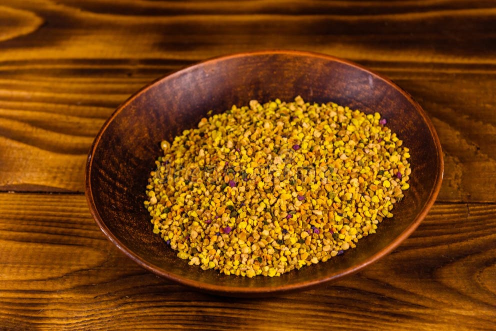 Ceramic Plate with Bee Pollen on Wooden Table Stock Photo - Image of ...