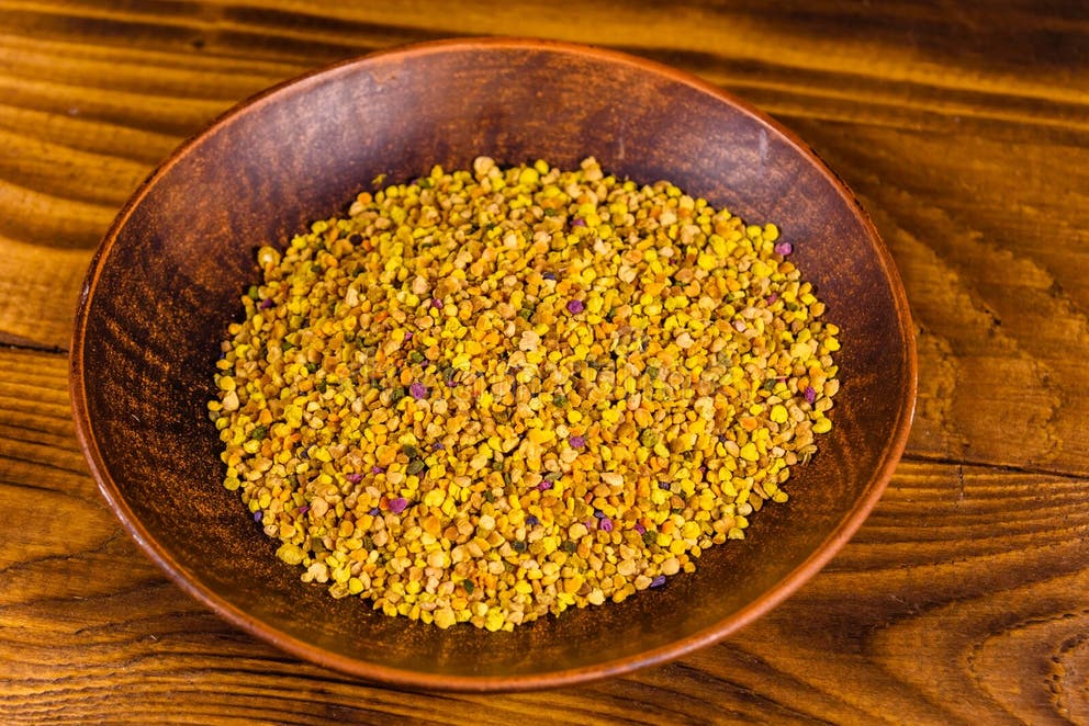 Ceramic Plate with Bee Pollen on Wooden Table Stock Photo - Image of ...