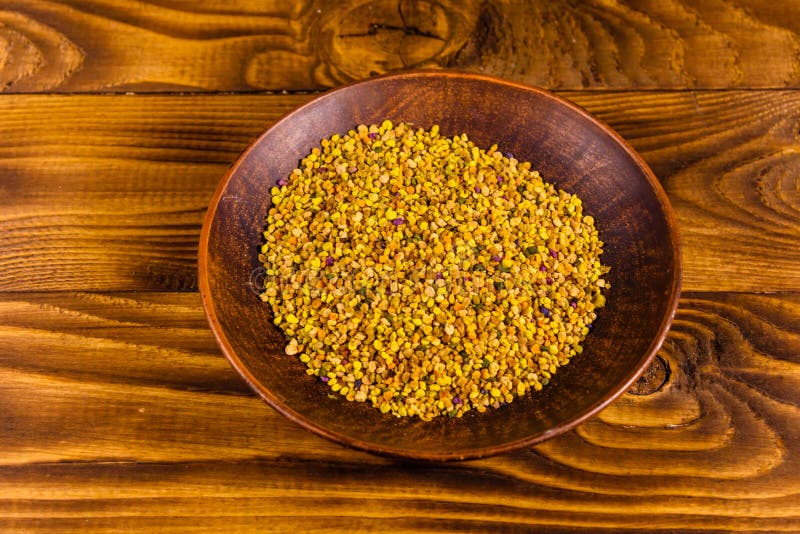 Ceramic Plate with Bee Pollen on Wooden Table Stock Image - Image of ...