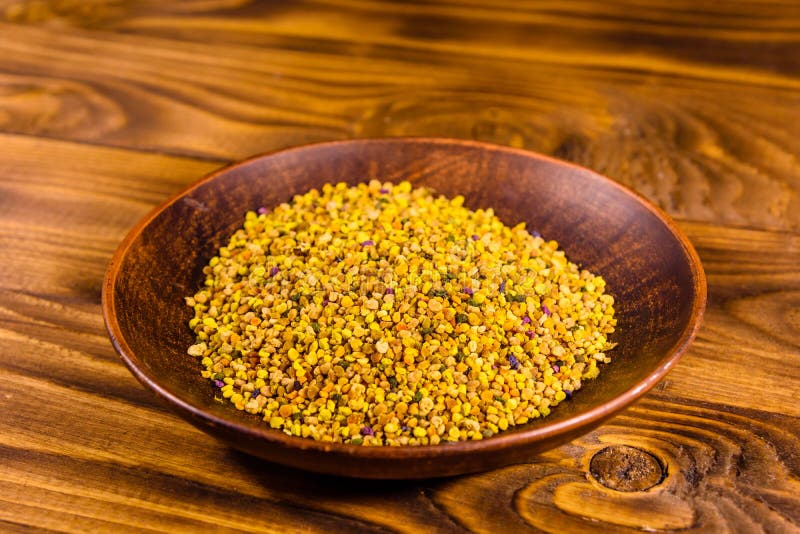 Ceramic Plate with Bee Pollen on Wooden Table Stock Image - Image of ...