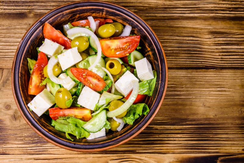 Ceramic Plate with Greek Salad on Wooden Table. Top View Stock Photo ...