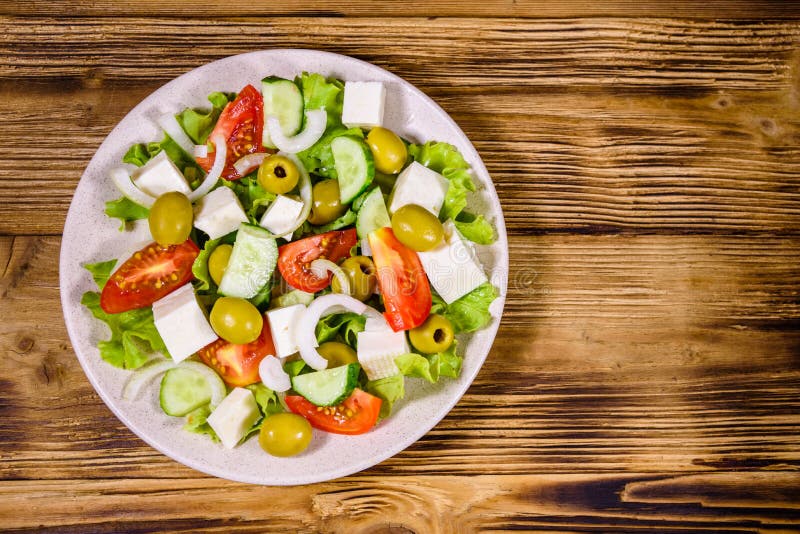 Ceramic Plate with Greek Salad on Wooden Table. Top View Stock Image ...
