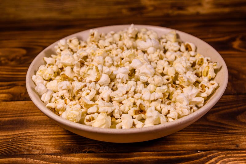 Ceramic Plate with Popcorn on Wooden Table Stock Image - Image of ...