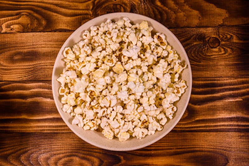 Ceramic Plate with Popcorn on Wooden Table. Top View Stock Photo ...