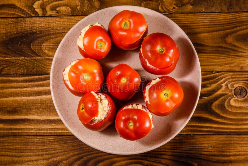 Ceramic Plate with Stuffed Tomatoes on Wooden Table. Top View Stock ...