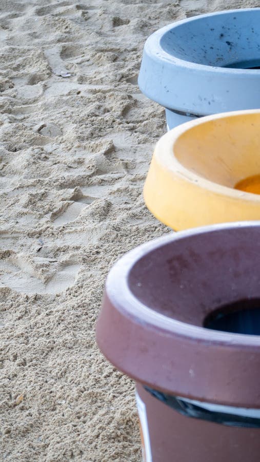 Ceramic Pots of Various Colors are Lined Up on the Beach Shore, Bathed ...