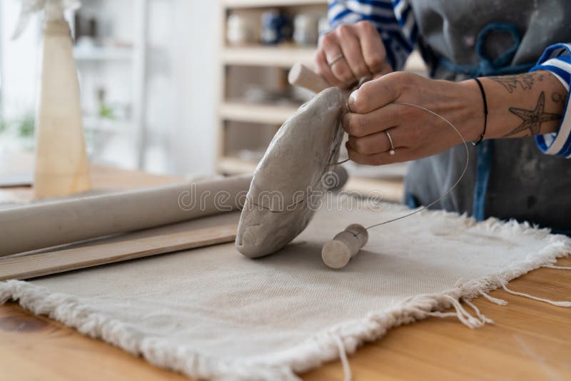 Craftswoman at Work Scraping and Shaping Clay Pottery Jug with ...