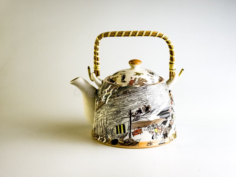 Ceramic Teapot with Abstract Pattern and Wicker Straw Handle on a White ...
