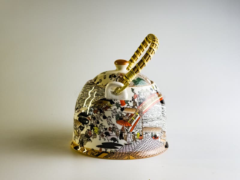 Ceramic Teapot with Abstract Pattern and Wicker Straw Handle on a White ...