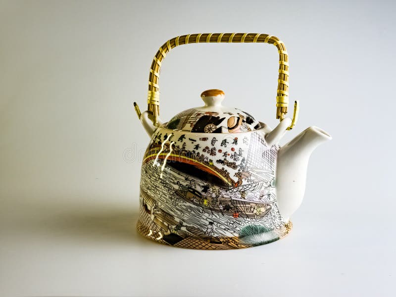 Ceramic Teapot with Abstract Pattern and Wicker Straw Handle on a White ...