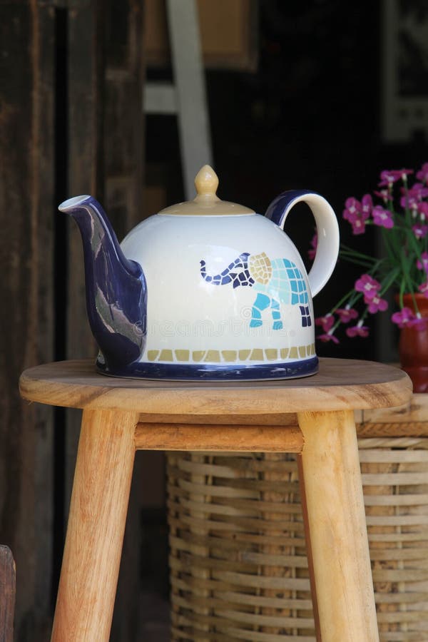 A ceramic teapot on table stock photo. Image of equipment - 256946992